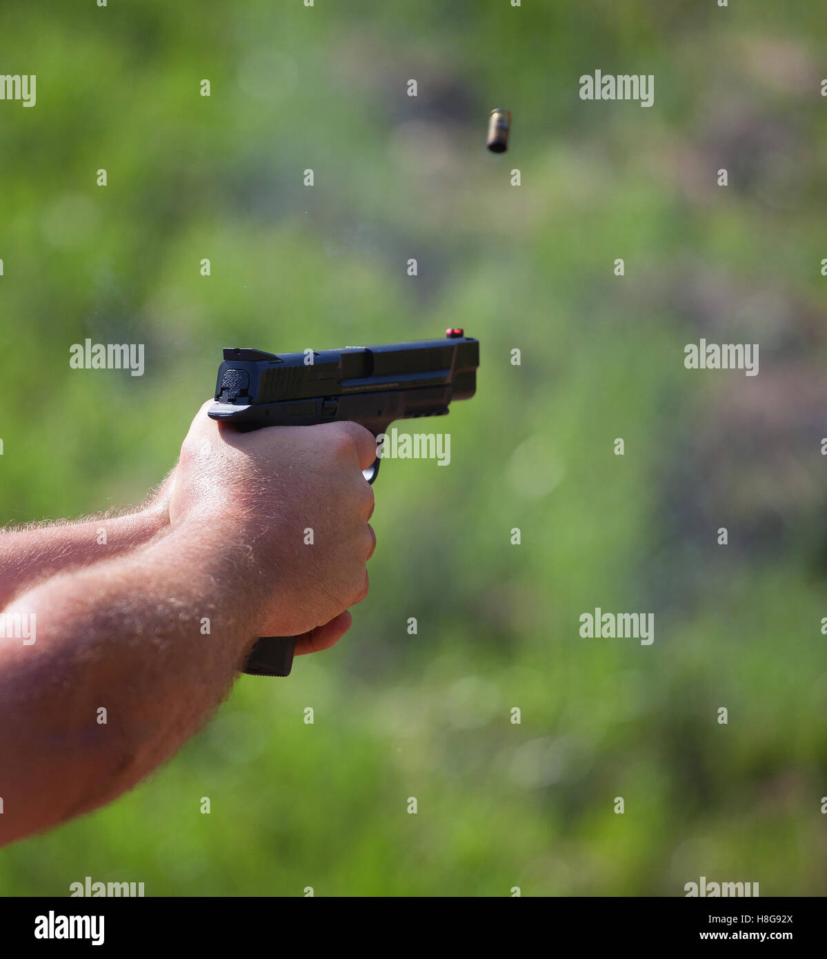 Empty cartridge as is flies from a handgun after being fired Stock ...