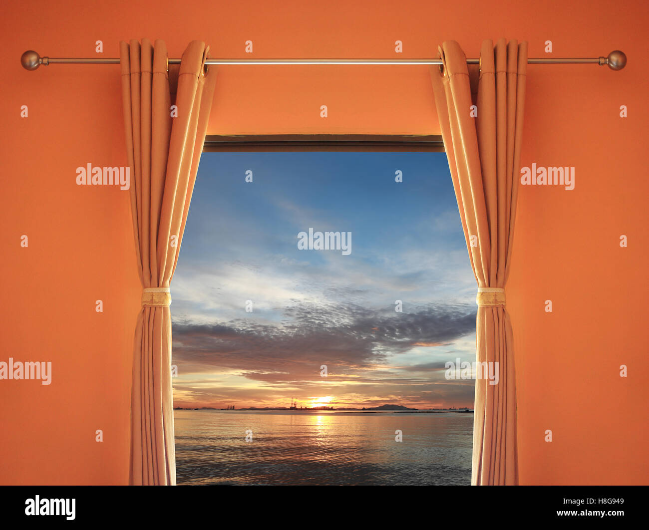 orange room have a window with blinds you can see sunset in evening for ...