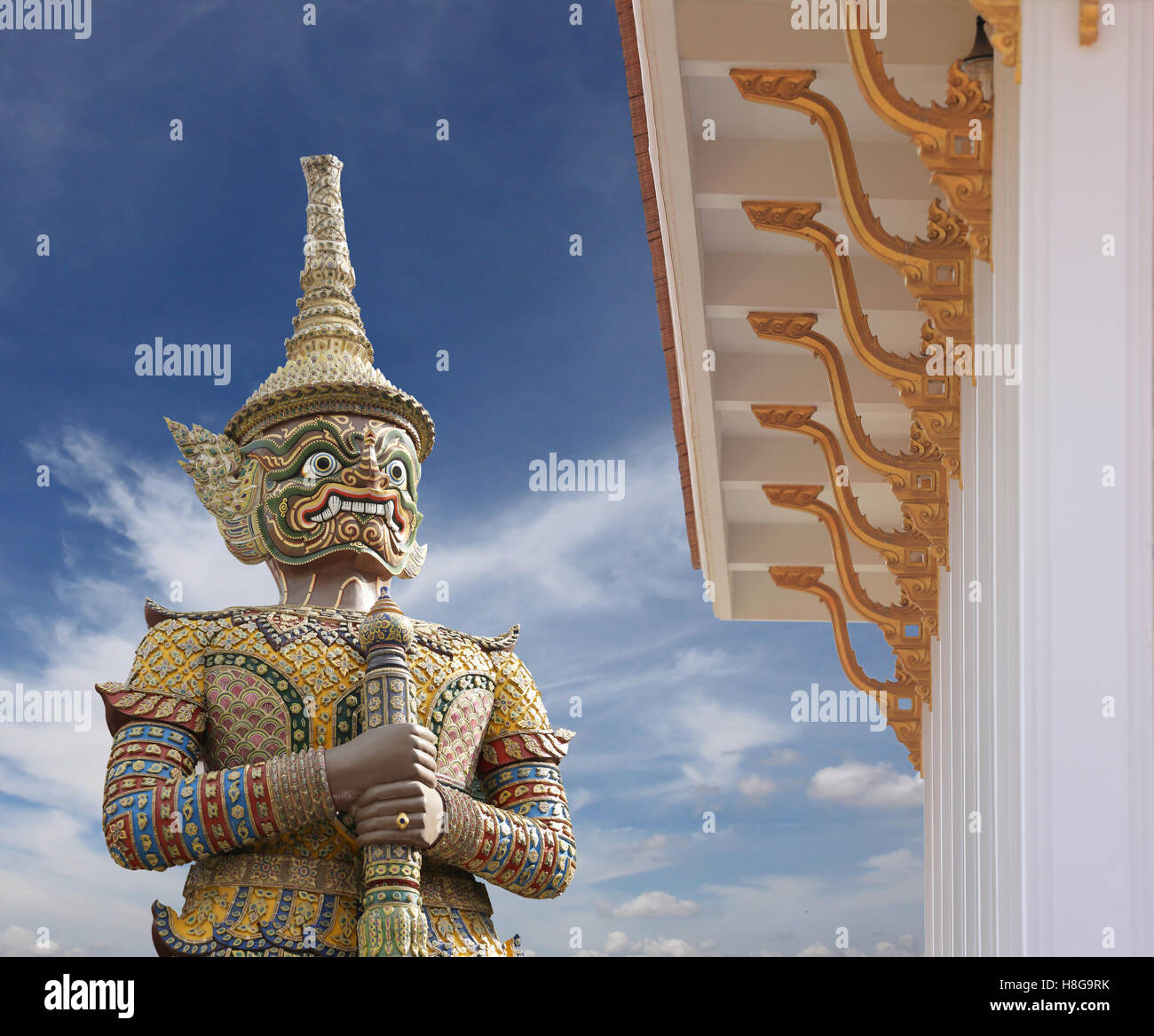 roof of the Thailand Buddhist temple and giant statue on blue sky ...