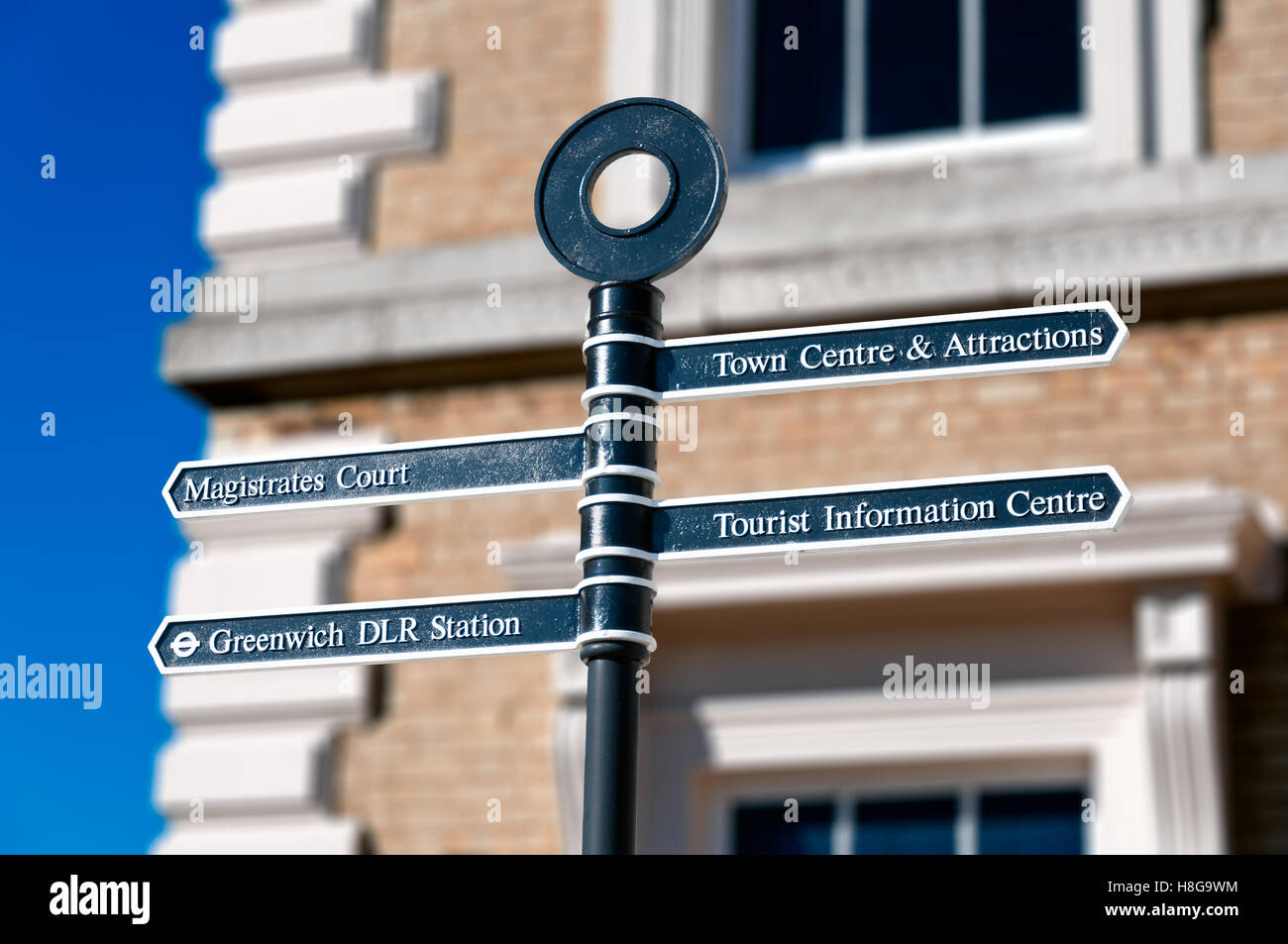 Metallic signpost with four signs to different destinations in London ...