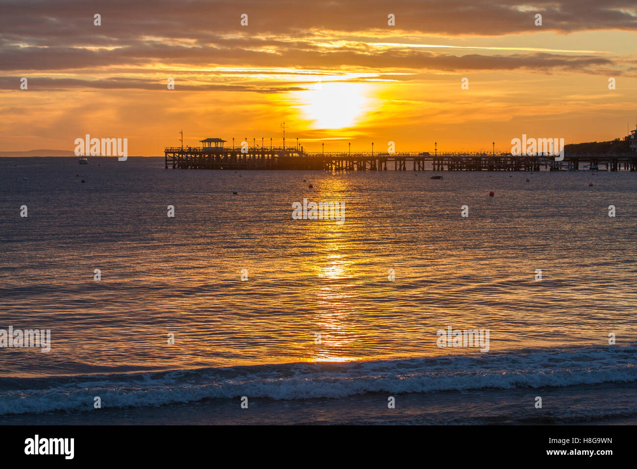 beautiful sun rising over silhouette in Swanage bay Stock Photo - Alamy