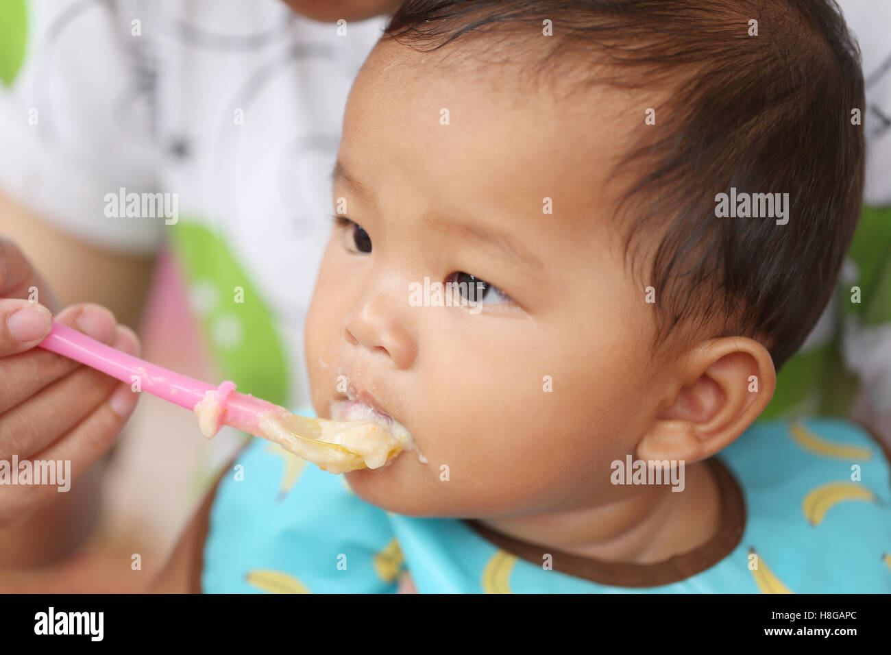 Asian baby boy to eating food in concept of health foods and nutrition ...