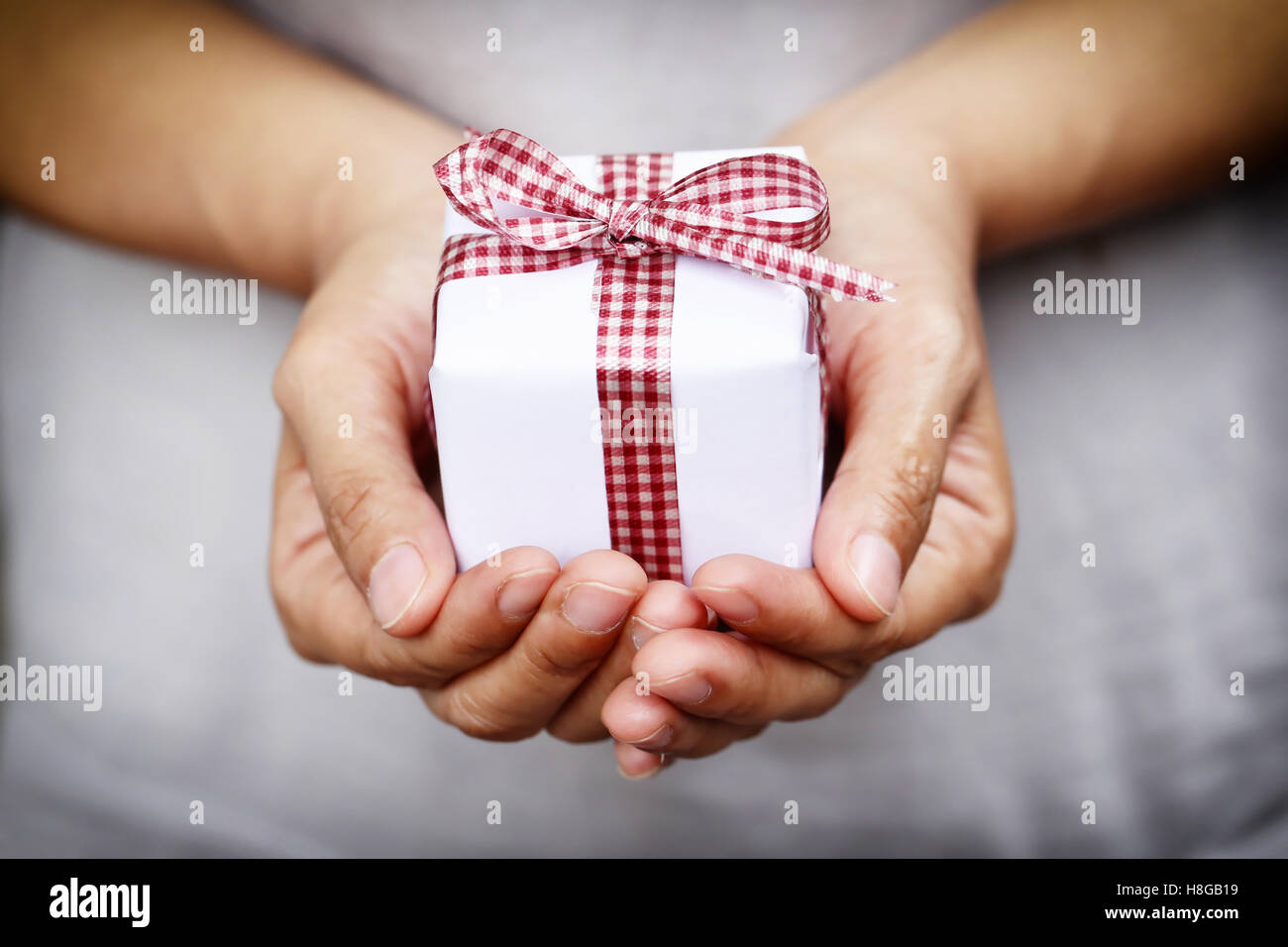 White Gift box on hand and Red Ribbon on gift box,Concept christmas Day ...