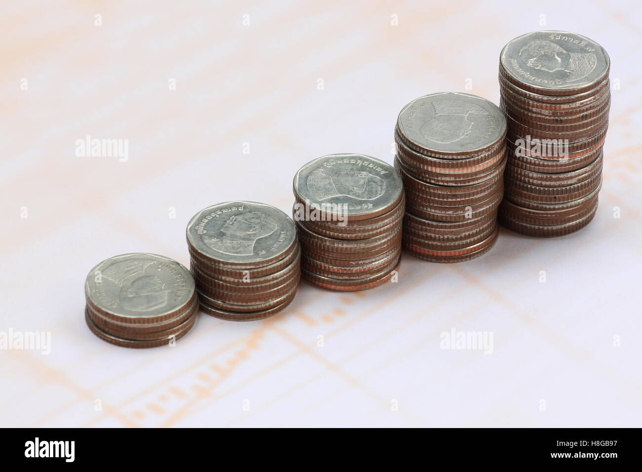 silver coin stack in business growth concept on paper background Stock ...