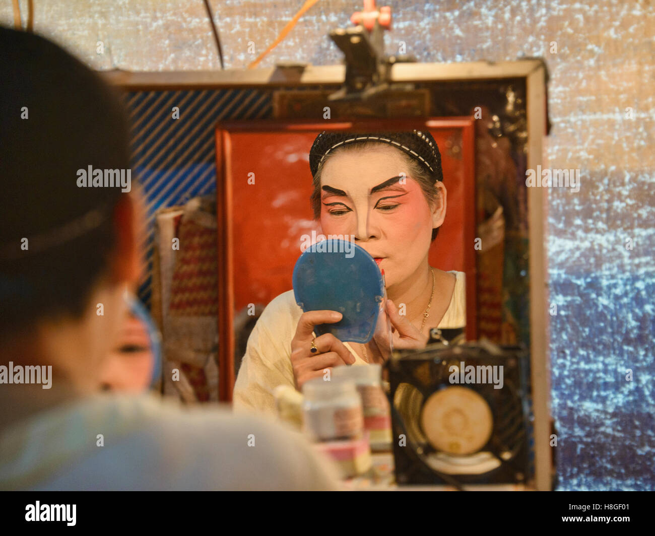 Chinese opera performer putting on her makeup at the Vegetarian ...