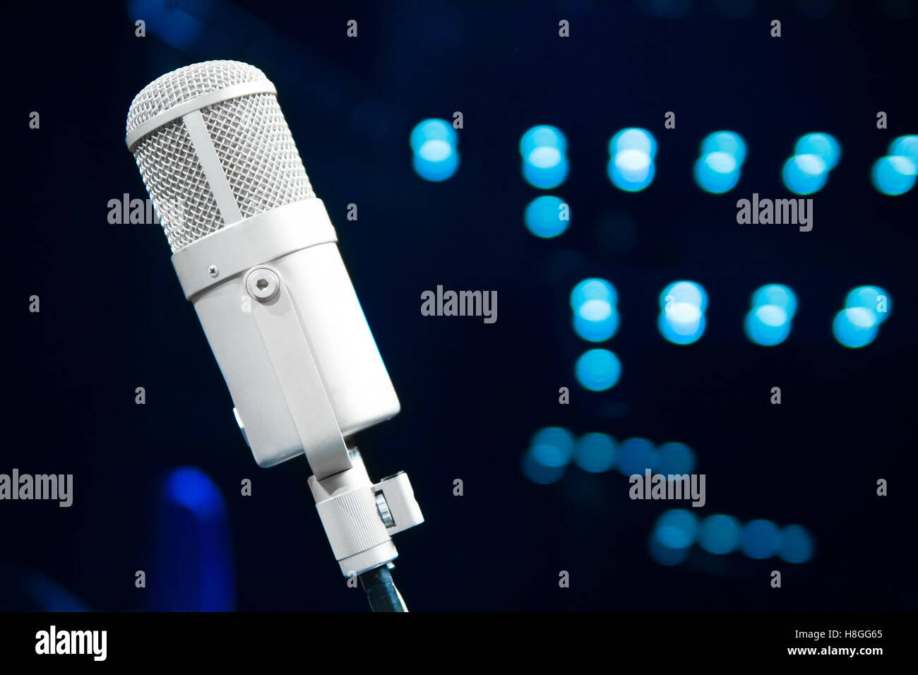 Close up of microphone with lights in background Stock Photo - Alamy