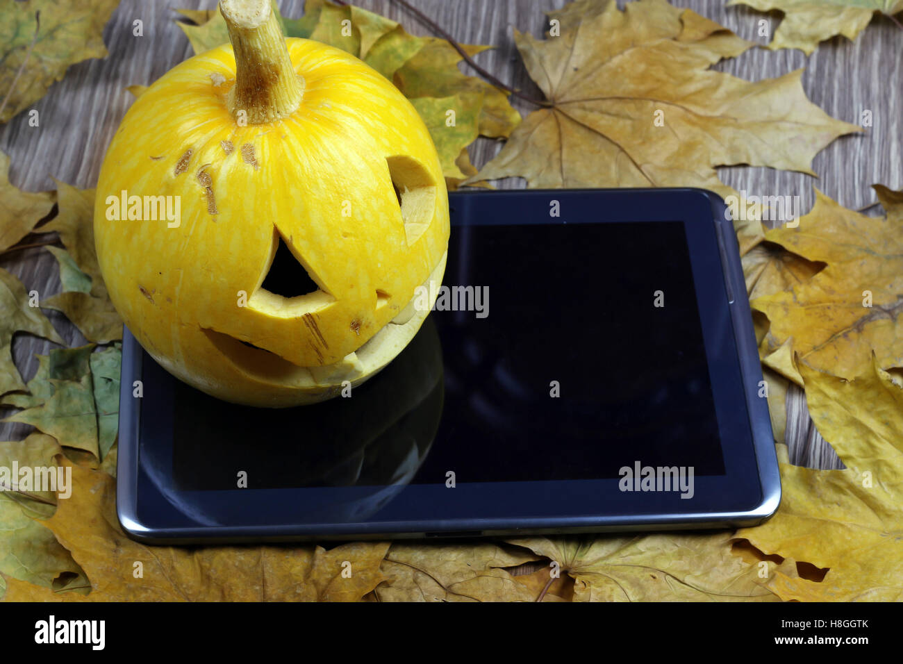 Halloween pumpkin and tablet Stock Photo - Alamy