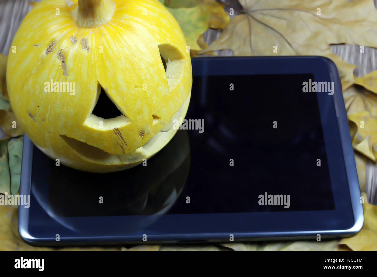 Halloween pumpkin and tablet Stock Photo - Alamy