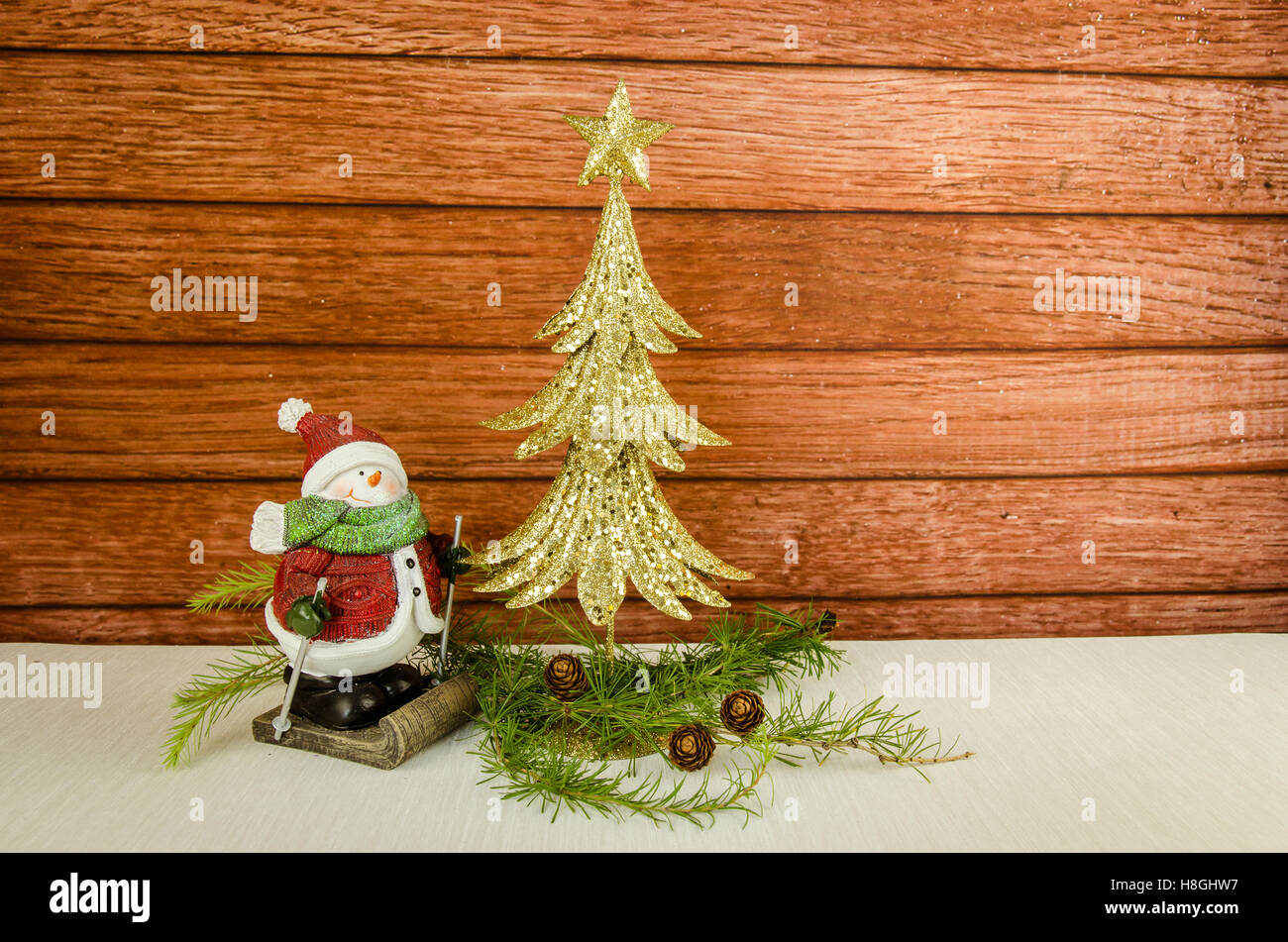 golden christmas tree, snowman and coniferous tree limb Stock Photo - Alamy