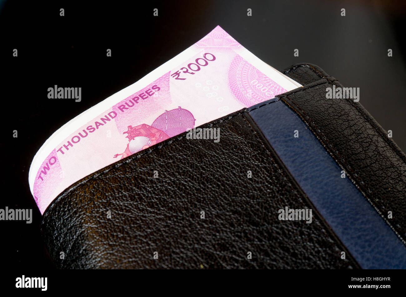 New Indian rupee 2000 note placed in a black leather wallet and ...