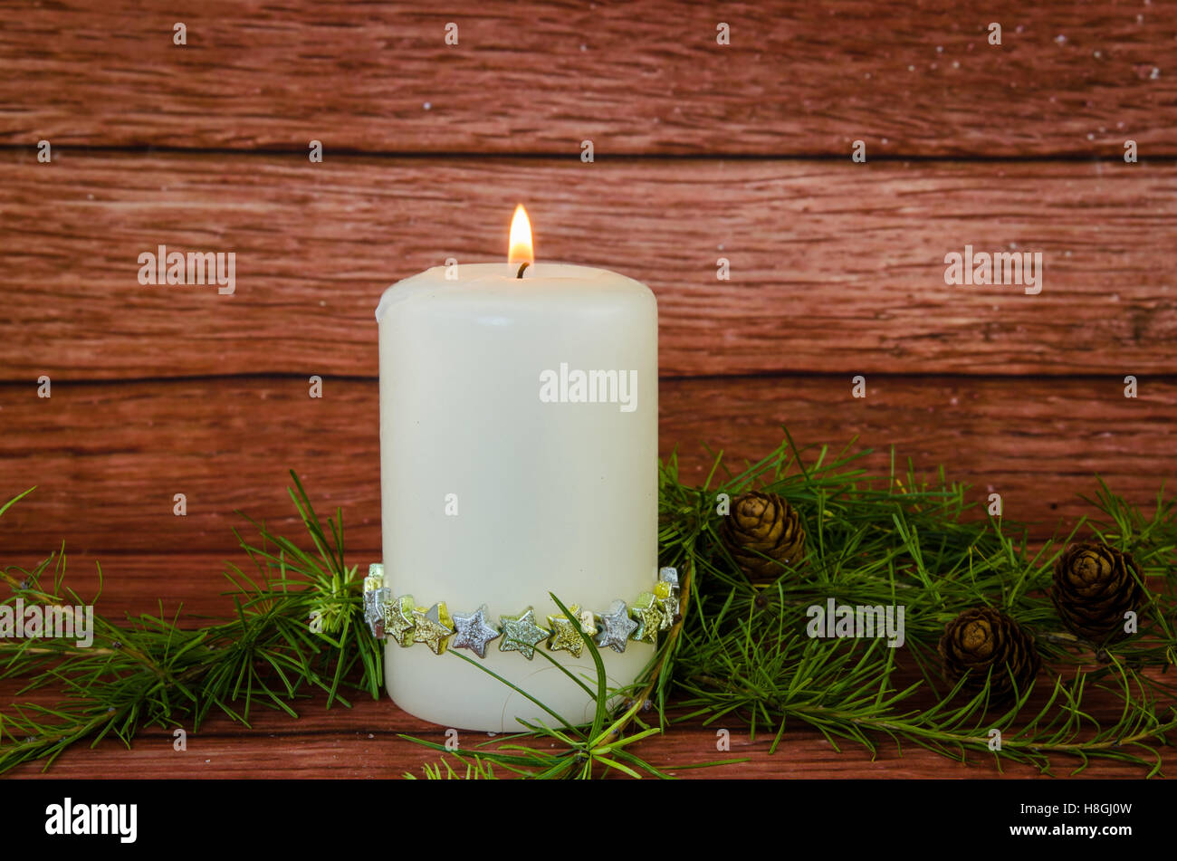 white burning candle and needle decoration Stock Photo - Alamy