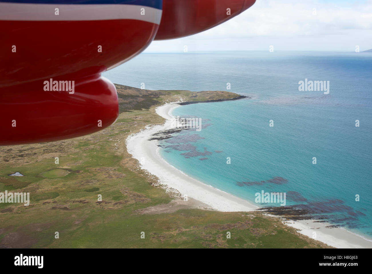 Aircraft flying over beautiful white sandy beaches and clear blue ...