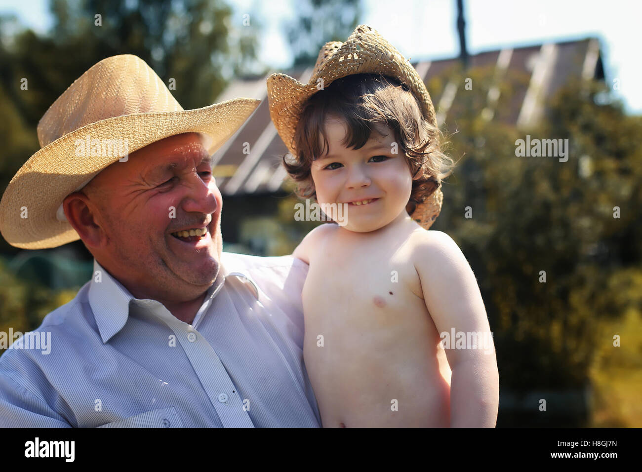 old man with child in hat Stock Photo - Alamy
