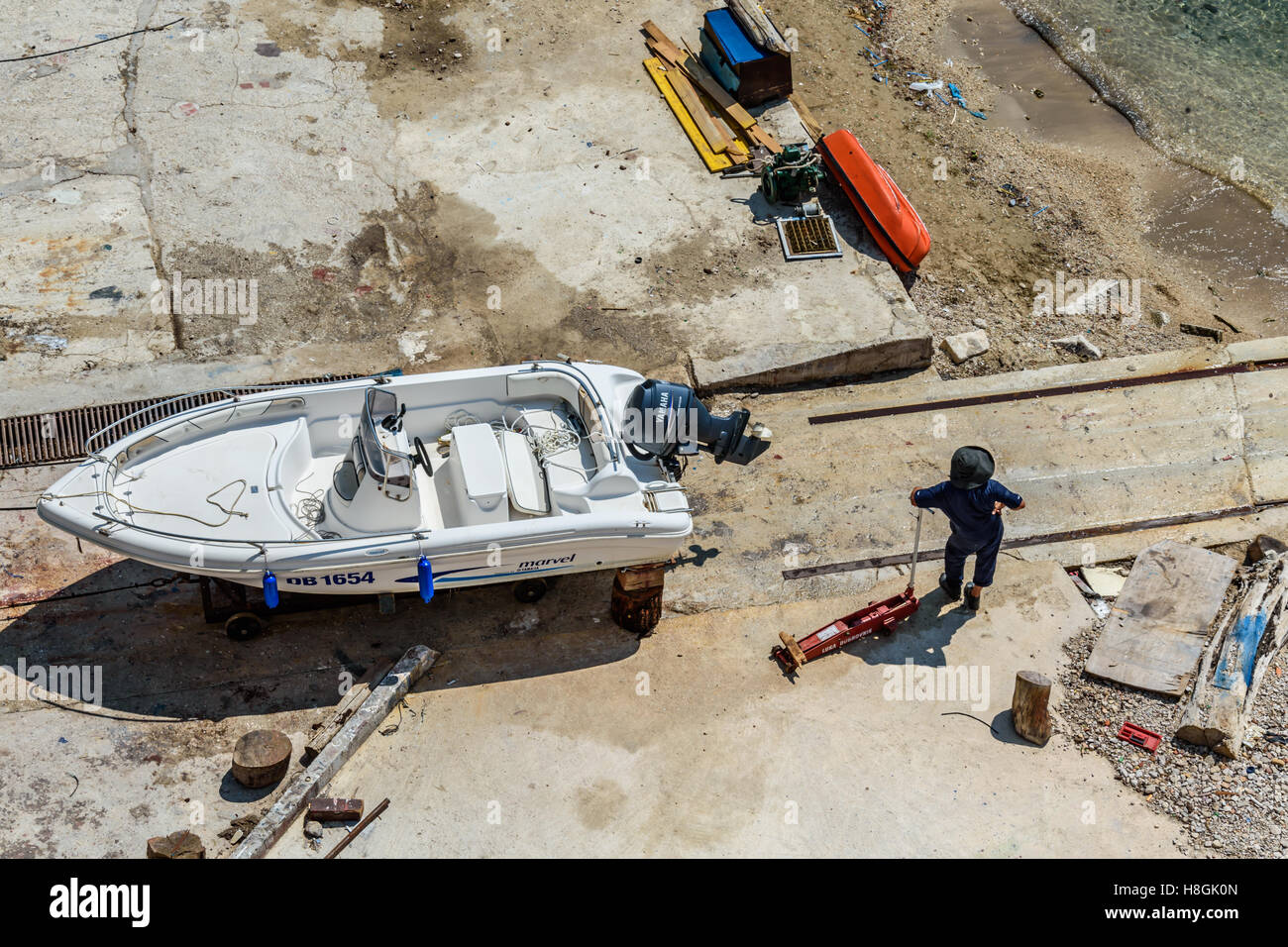Man going to repair his boat Stock Photo - Alamy