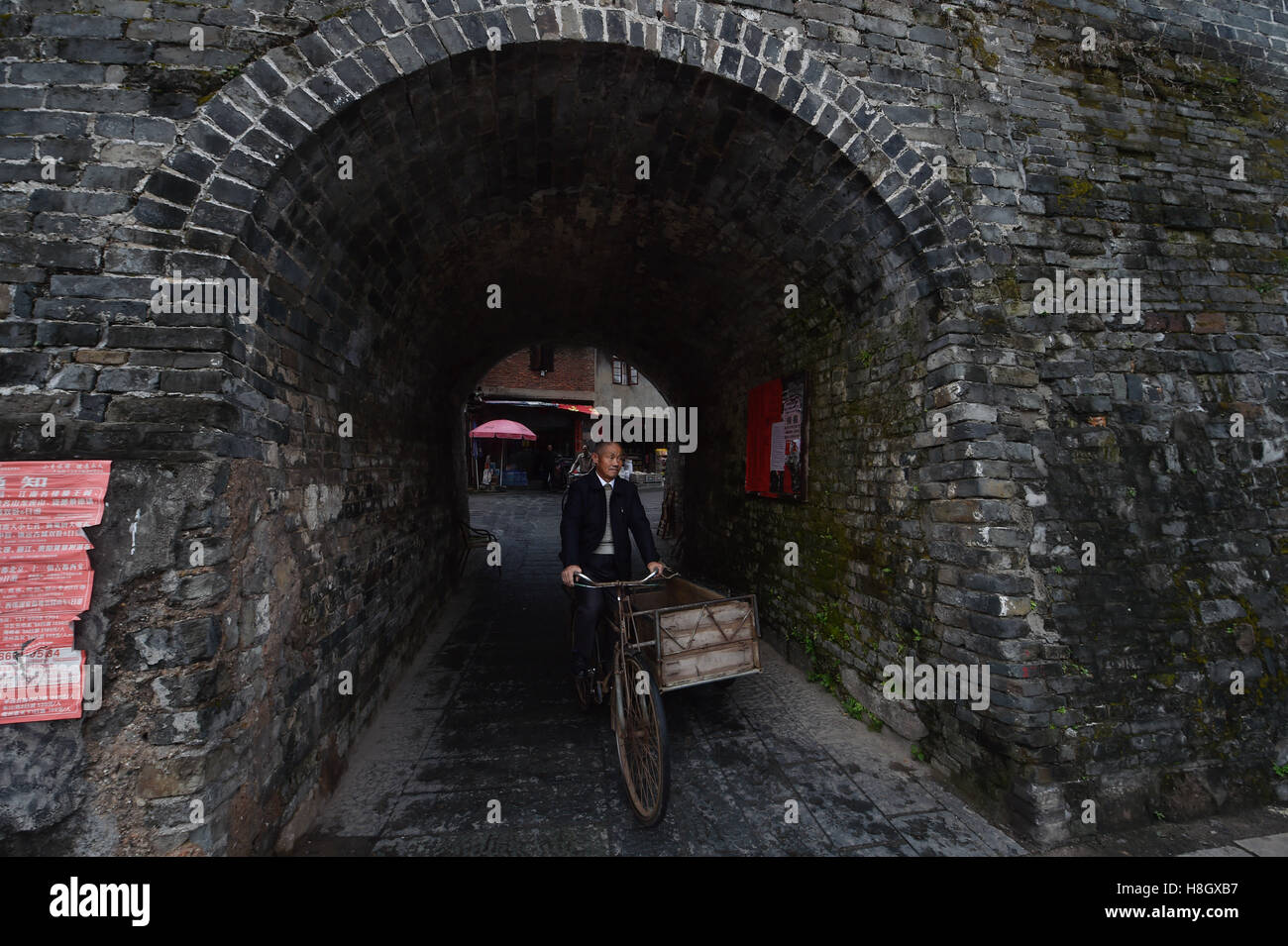 Changting, China's Fujian Province. 13th Nov, 2016. A man rides beneath ...