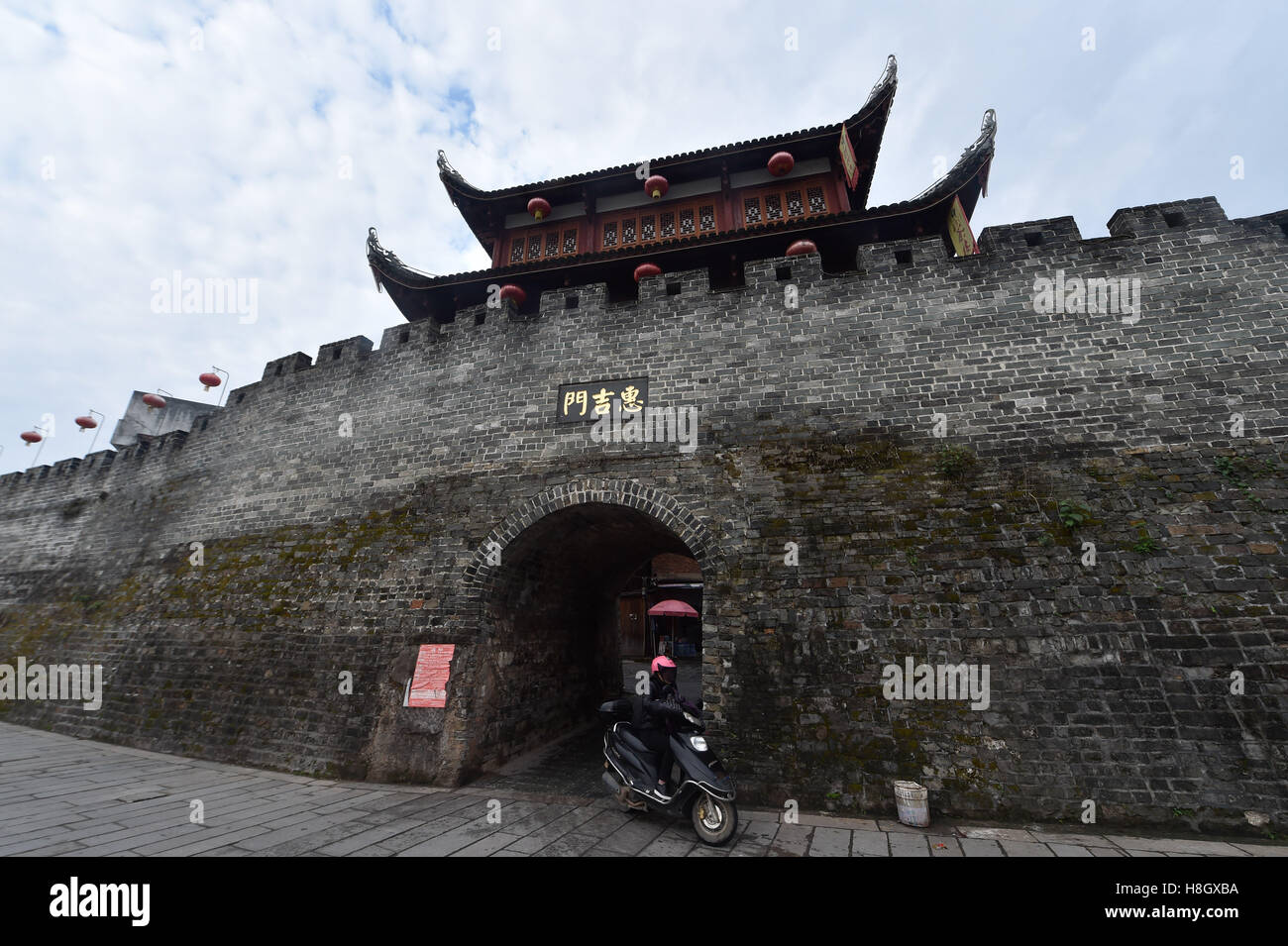 Changting, China's Fujian Province. 13th Nov, 2016. A man rides past ...
