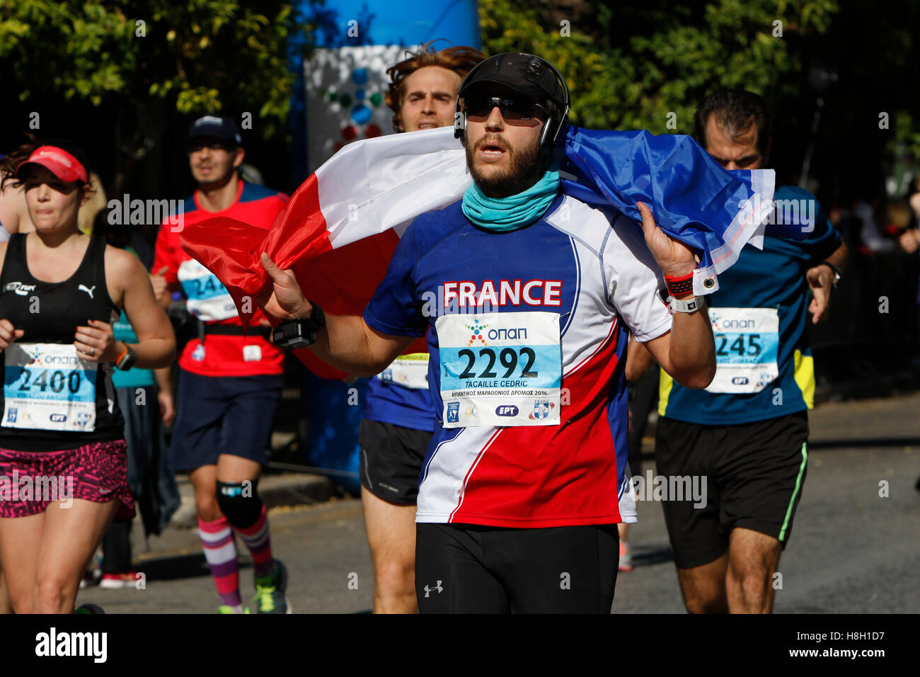 Athens, Greece. 13th November 2016. A runner is wrapped in a French ...