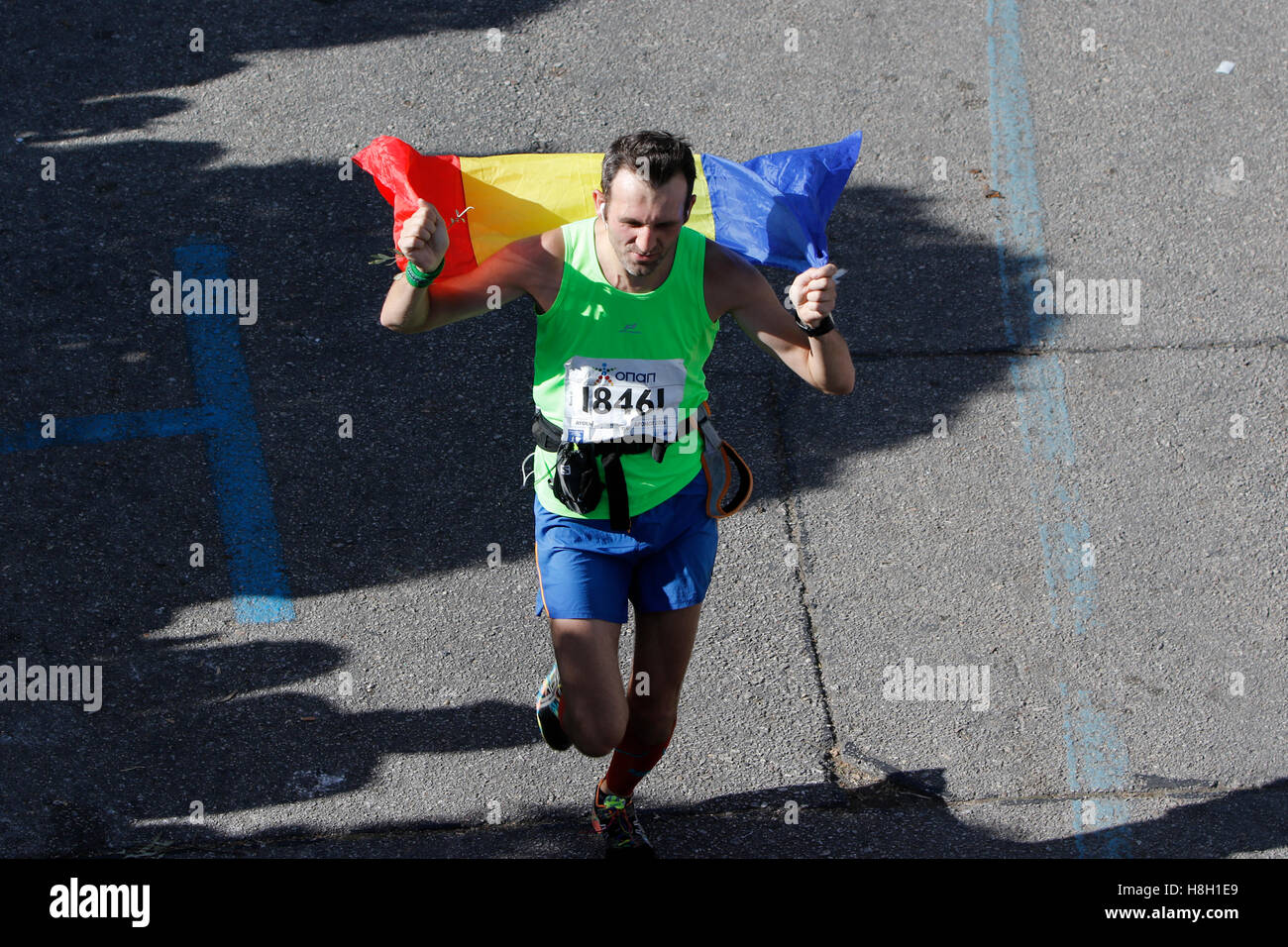 Athens, Greece. 13th November 2016. A runner carries a Romanian flag ...