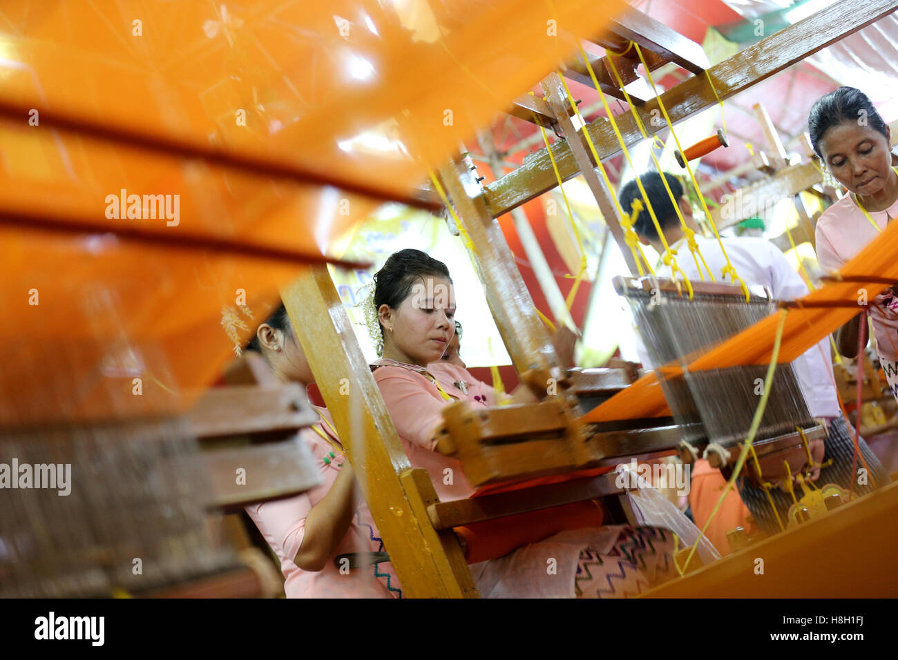 Yangon, Myanmar. 13th Nov, 2016. Women compete weaving robes at ...