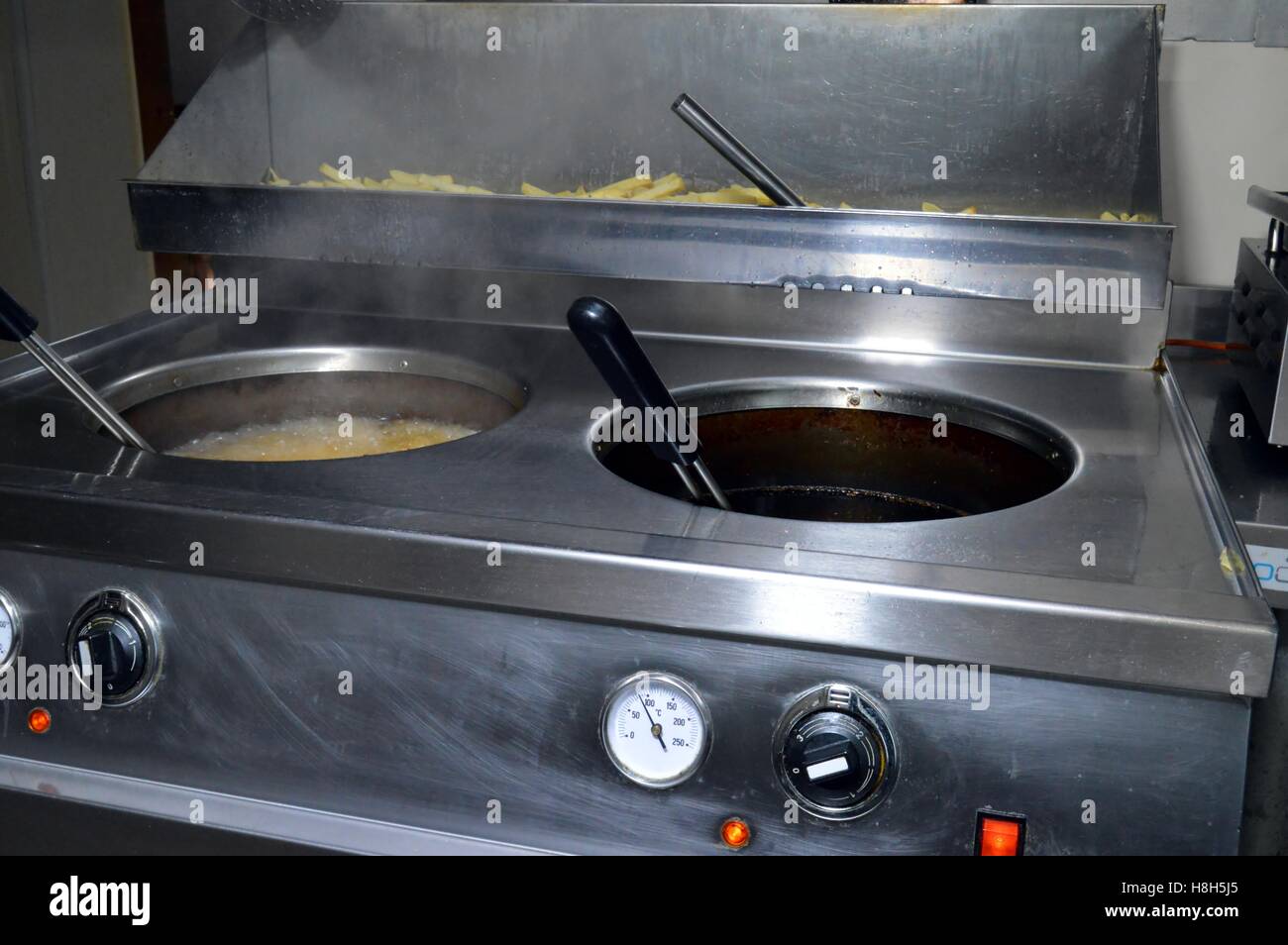Professional stainless steel fryer with pre-cooking fries Stock Photo ...