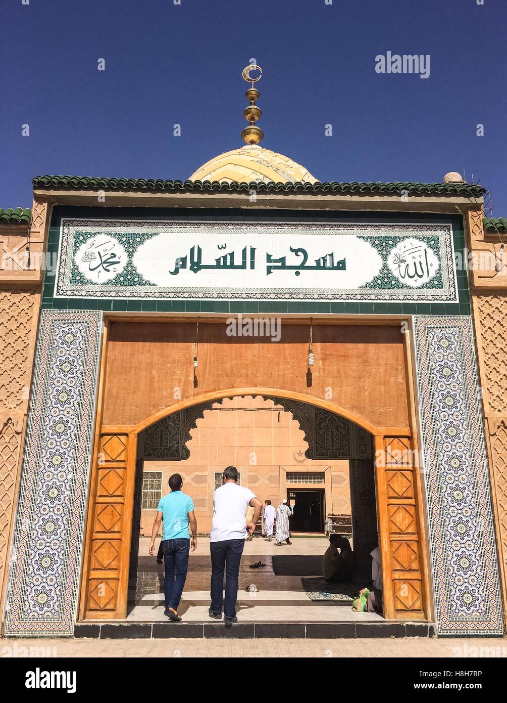 Madjid Essalam mosque in Bechar. People moving out from the Friday pray ...