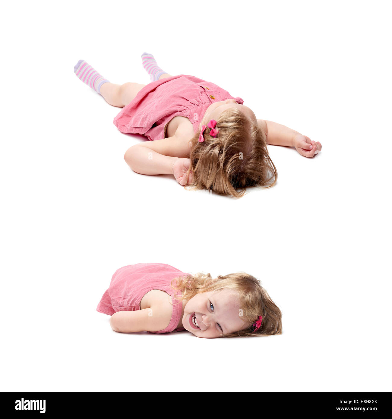 Young little girl lying over isolated white background Stock Photo - Alamy