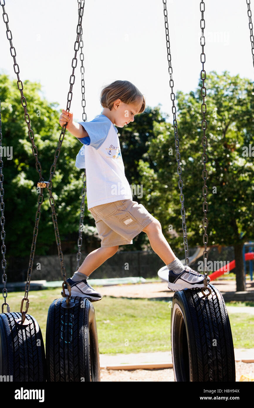 Young boy playing in the park Stock Photo - Alamy