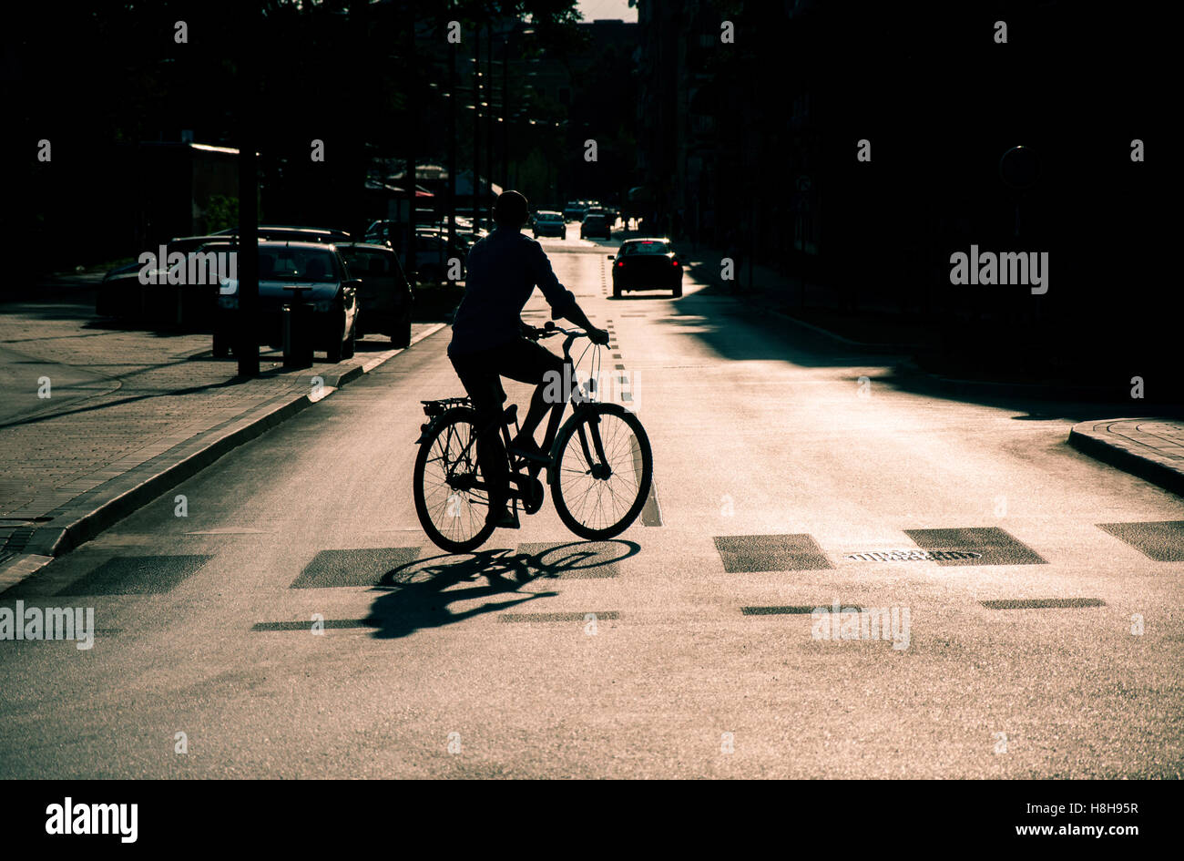 Cyclist on bicycle crossing the street Stock Photo - Alamy