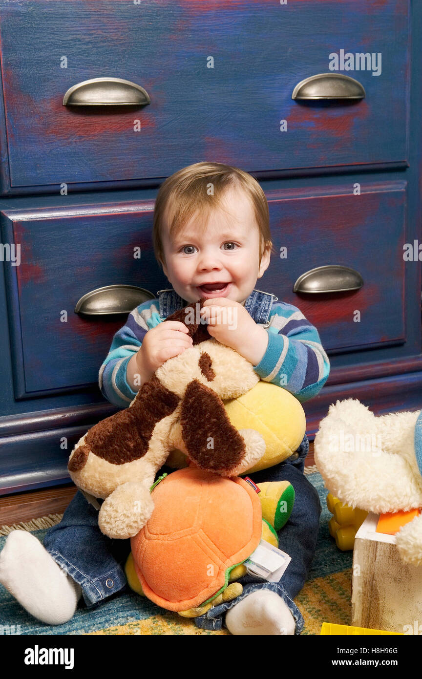 Young male child holding his stuffed toy Stock Photo - Alamy