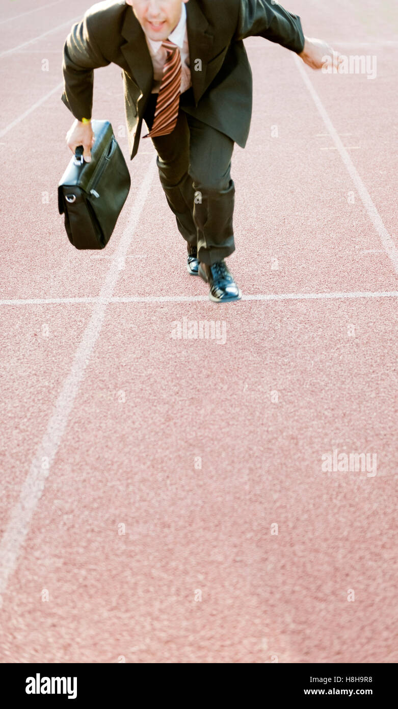 Businessman on running track Stock Photo - Alamy