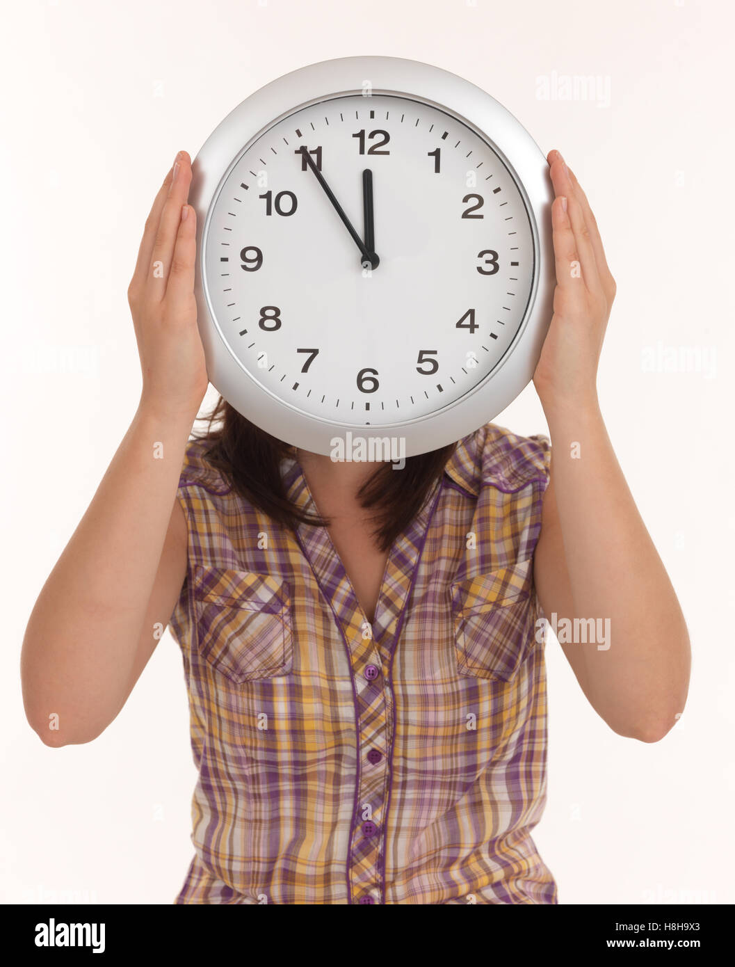 Woman with a clock Stock Photo - Alamy