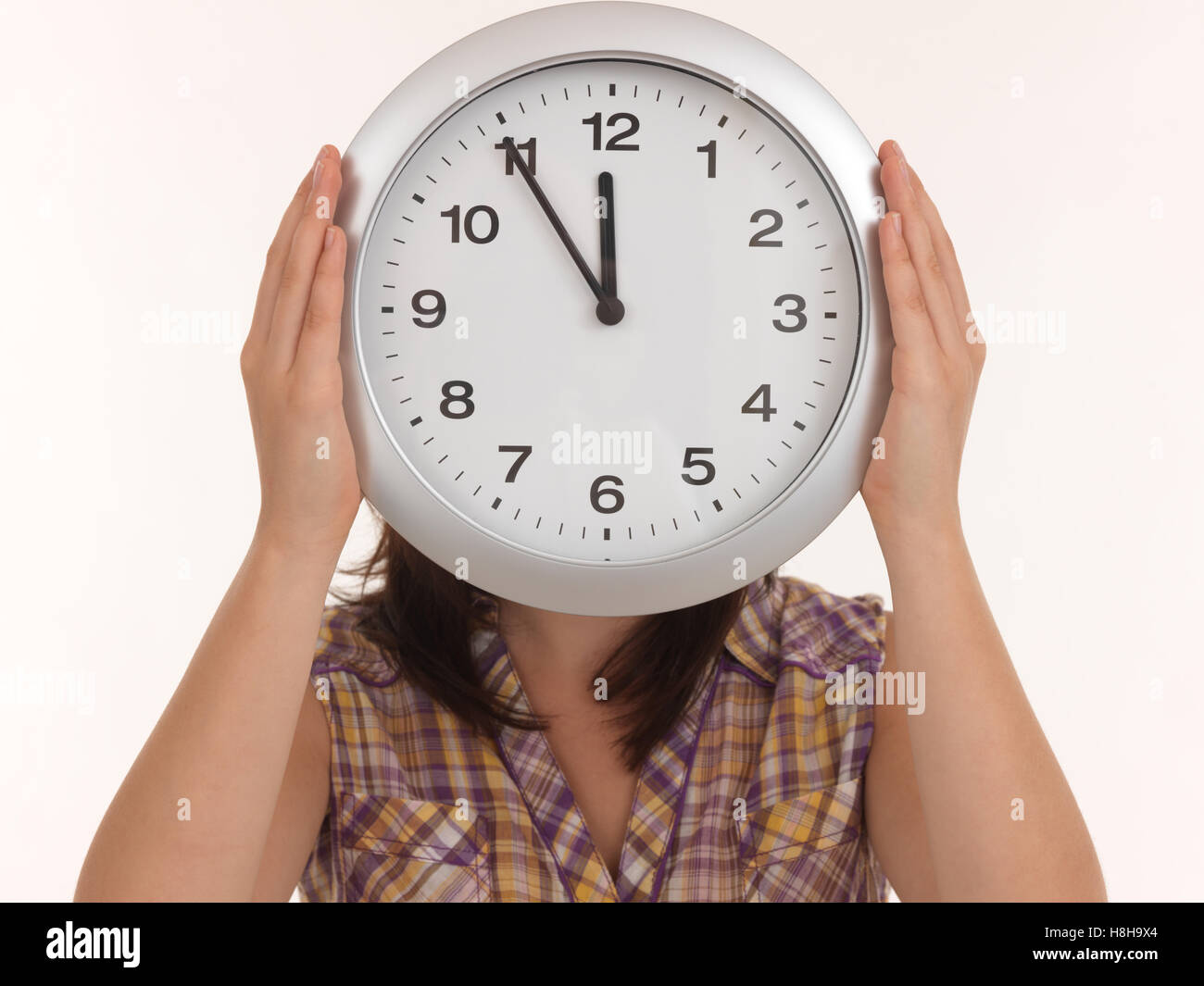 Woman with a clock Stock Photo - Alamy