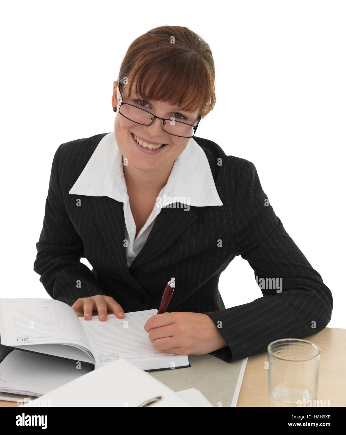 Businesswoman writing into her appointment calendar Stock Photo - Alamy