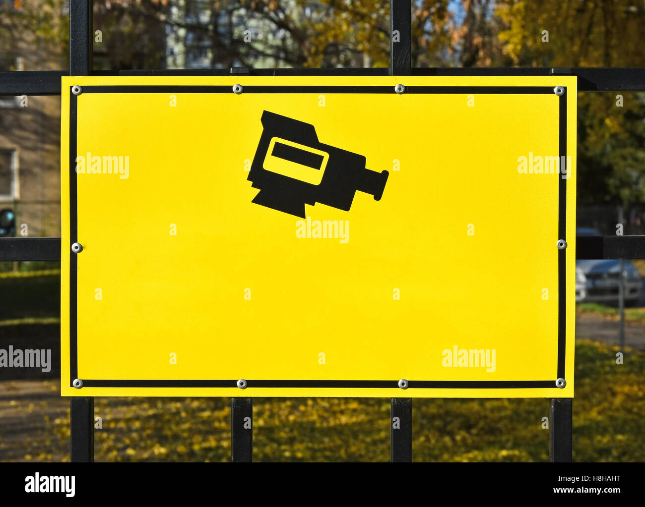 Security camera sign on the fence of a house Stock Photo - Alamy