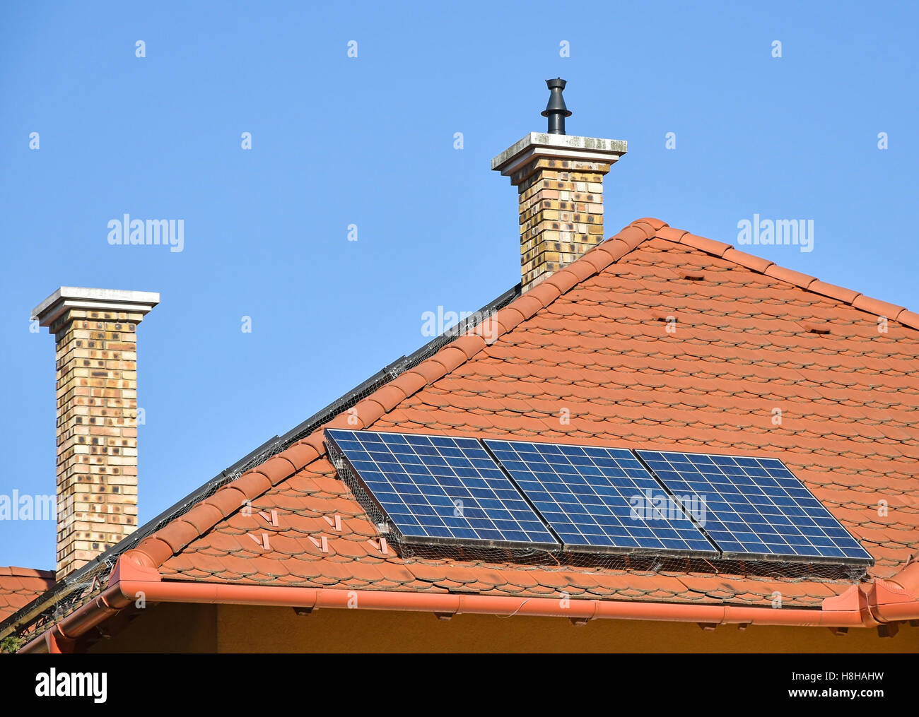 Solar panels and smoke stacks on the roof Stock Photo - Alamy