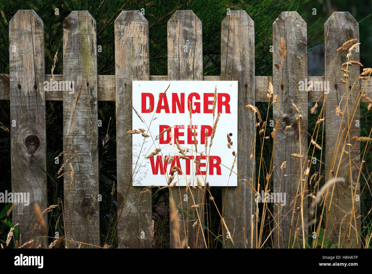 Danger Deep Water sign fitted to wooden fence Stock Photo - Alamy