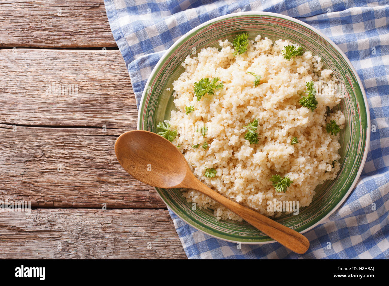 steamed bulgur with parsley close-up on a plate on the table ...