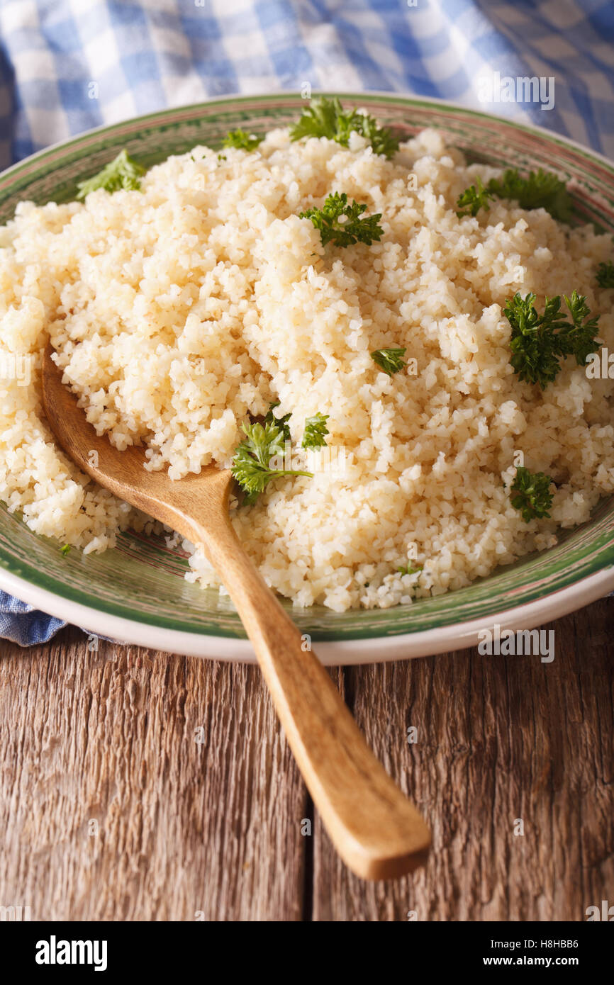 Bulgur with parsley close-up on a plate on the table. Vertical Stock ...