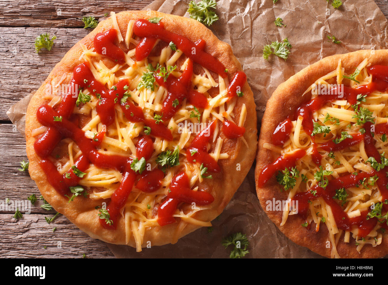 Homemade Hungarian langos with cheese and ketchup on the table close-up ...