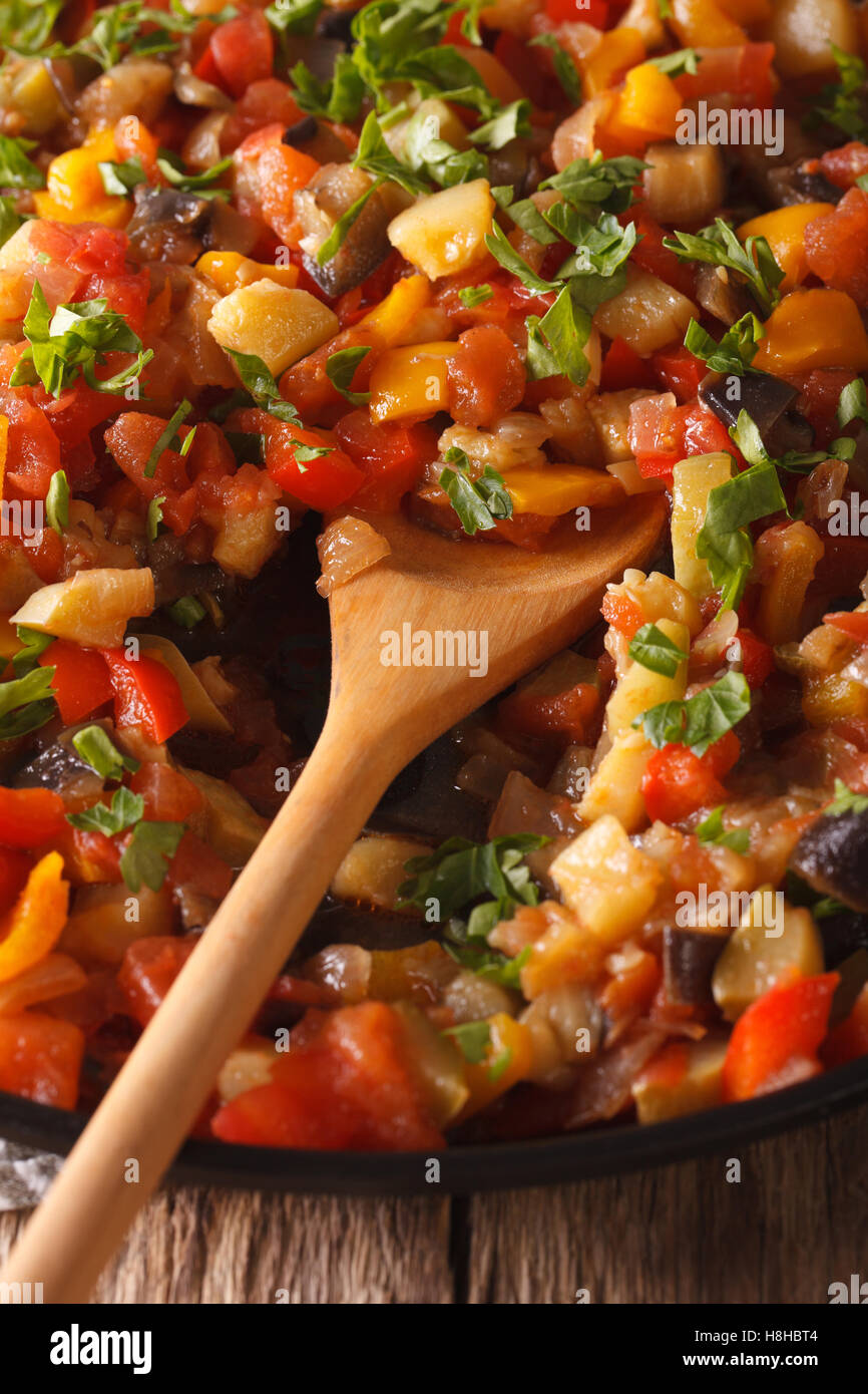 Spanish vegetable stew Pisto macro on a plate on the table. vertical ...