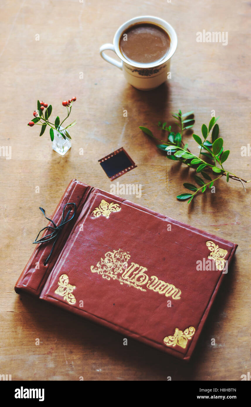 Top view of vintage photo album and coffee on table Stock Photo - Alamy