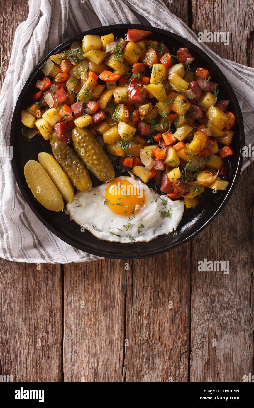 Finnish food pyttipannu: fried potatoes with sausages, eggs and pickled ...
