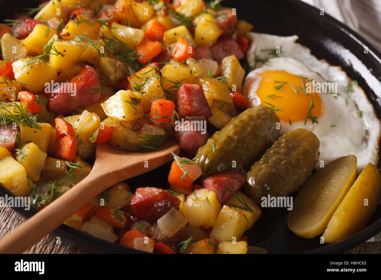 Scandinavian breakfast: pyttipanna with fried eggs and pickled ...