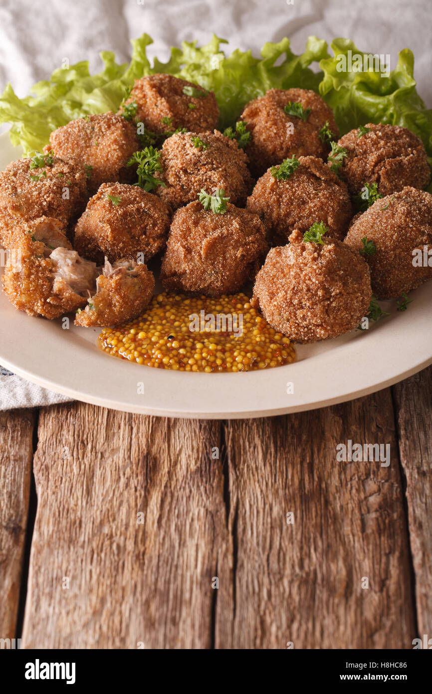 Dutch meat croquettes Bitterballen and mustard close up on a plate on ...