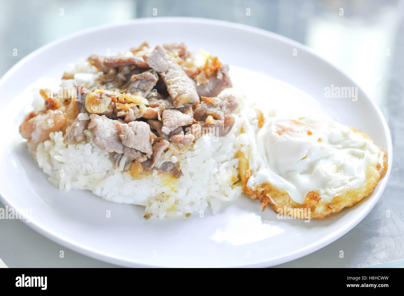 Rice with fried pork with garlic and pepper Stock Photo - Alamy