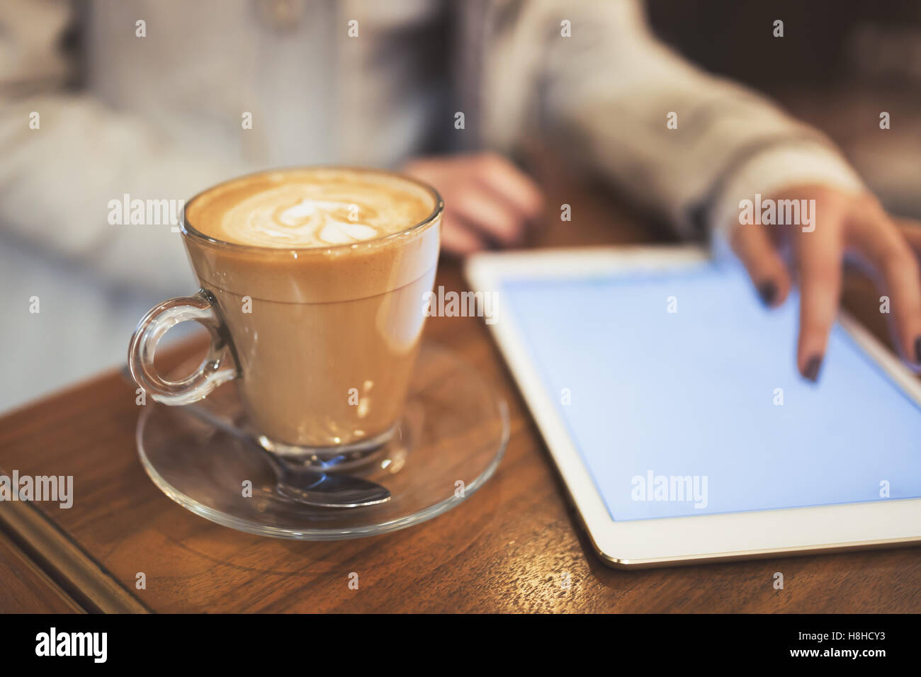 Woman using tablet in restaurant while on coffee break Stock Photo - Alamy