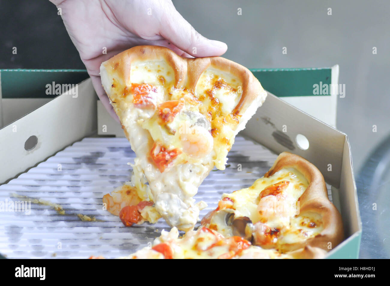 pick up a slice of pizza pick up a slice of pizza Stock Photo - Alamy