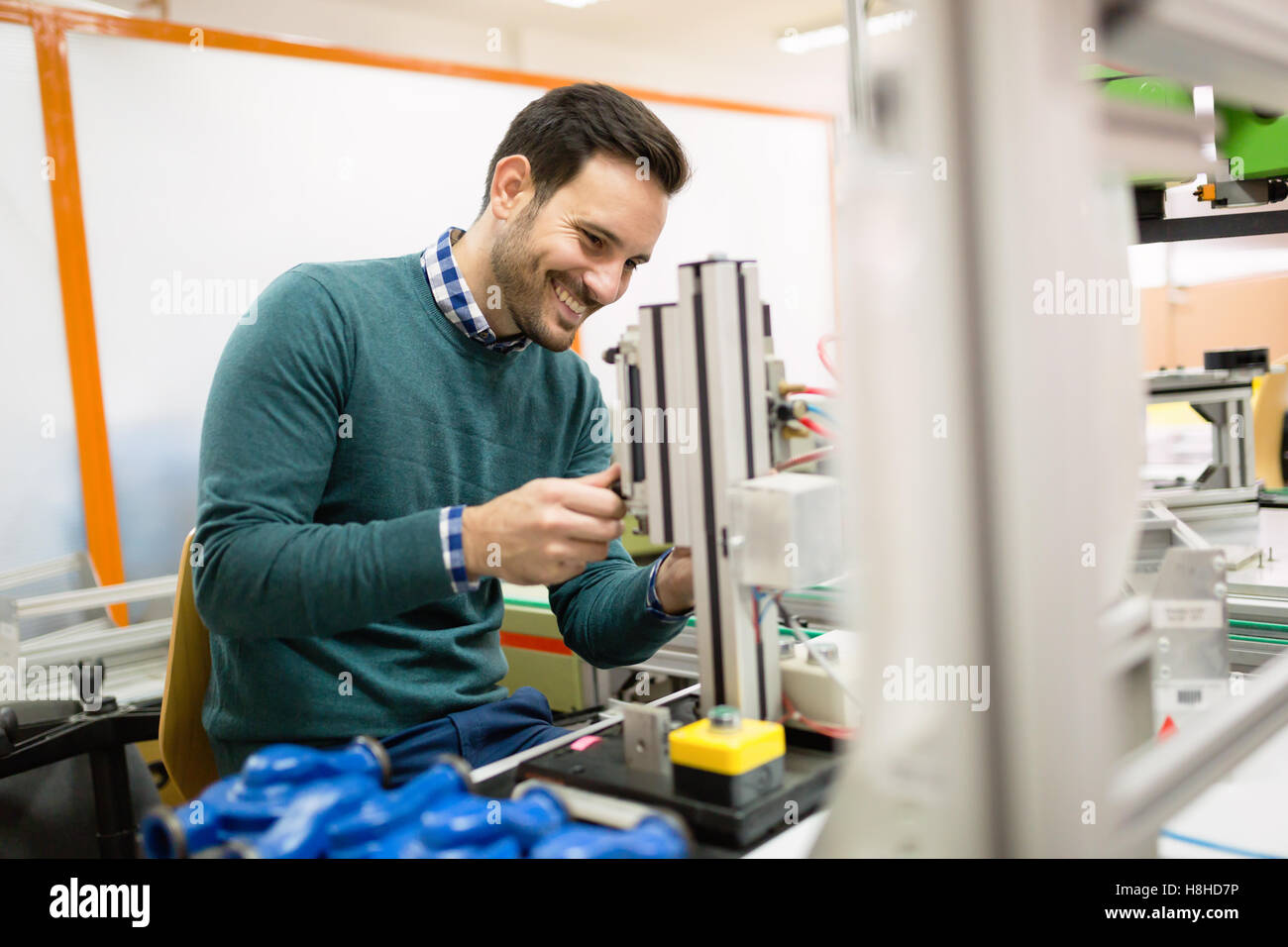 Creative mechanical engineer working on machines Stock Photo - Alamy