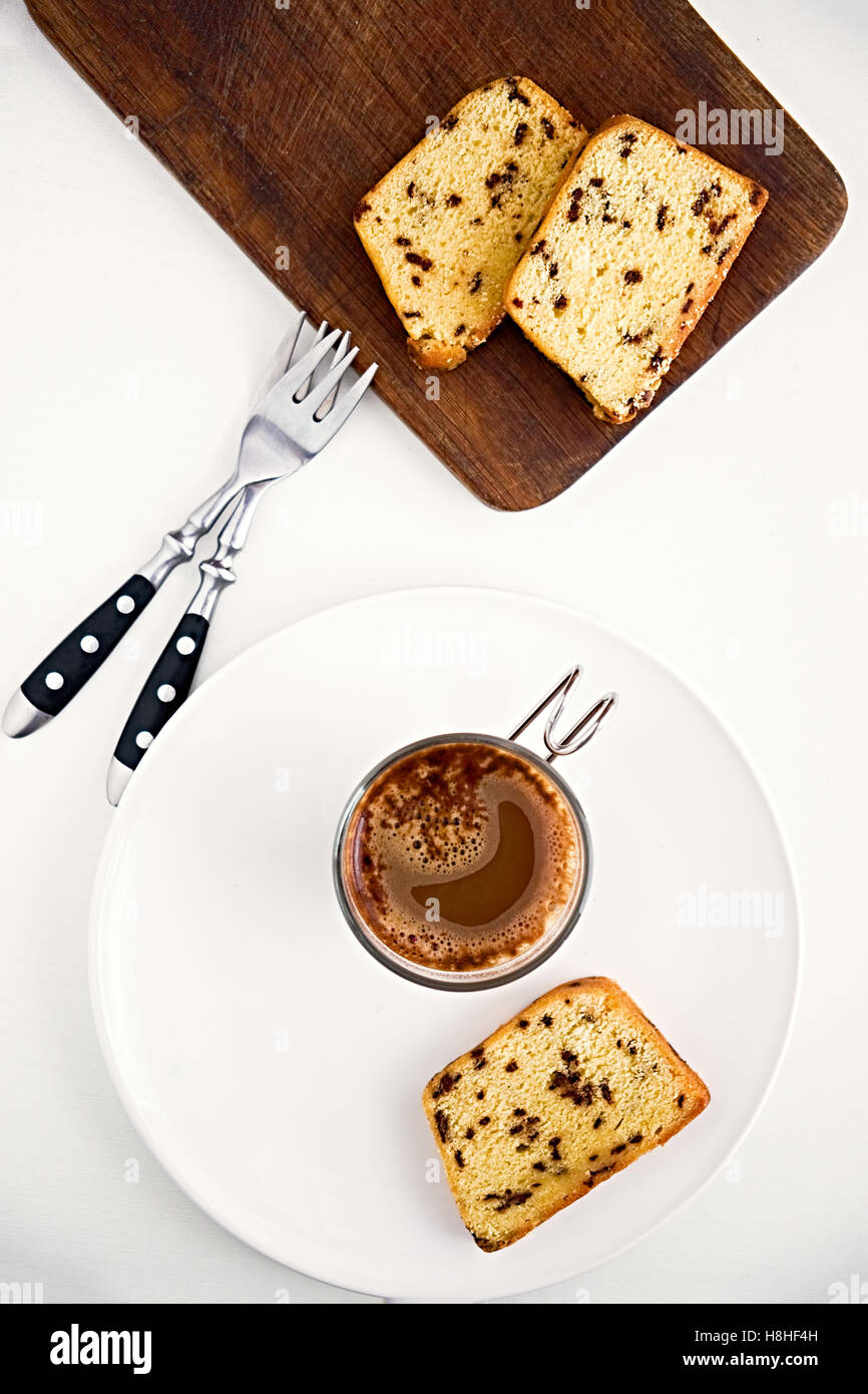Morning coffee with chocolate chip cake on a white plate and white ...