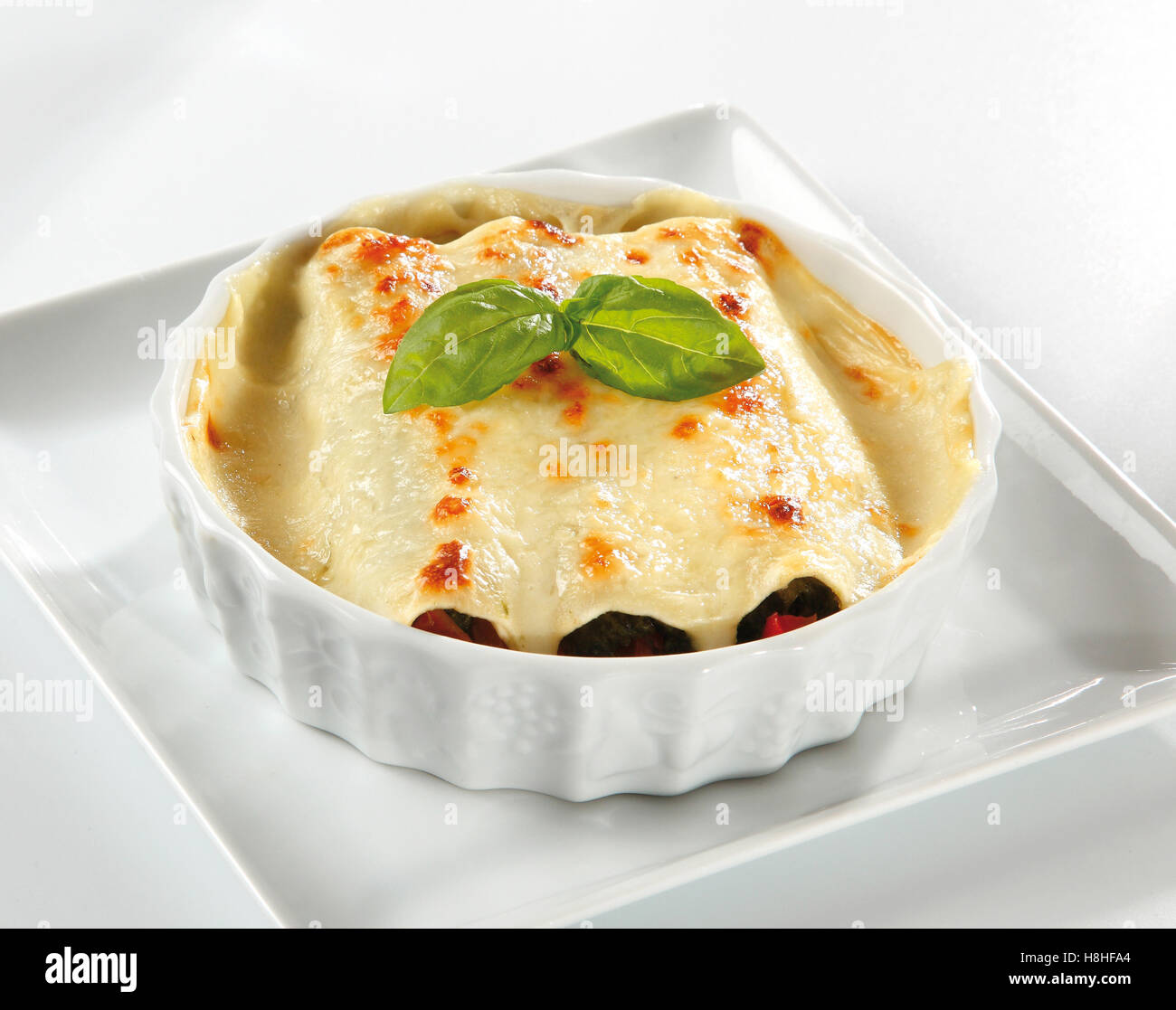 Meat cannelloni with a bechamel sauce gratin Stock Photo - Alamy